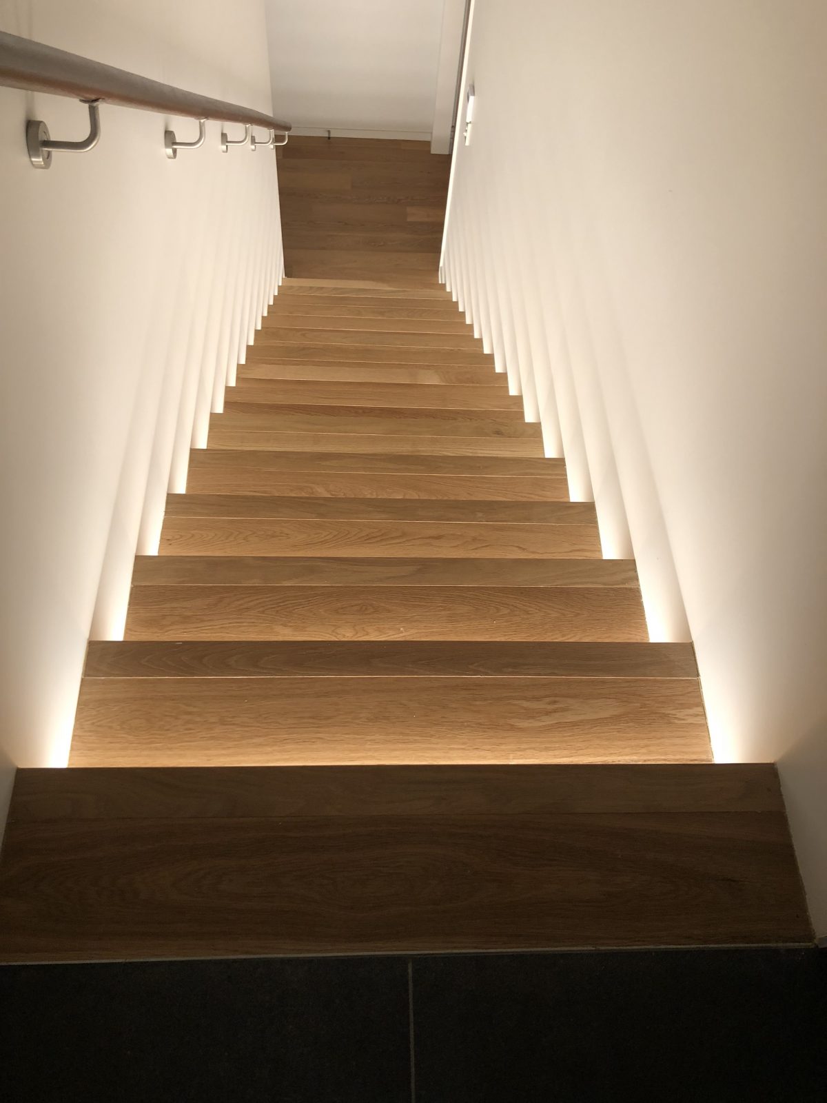 LED strip lights set into stair risers. - Astrum Lighting and Design